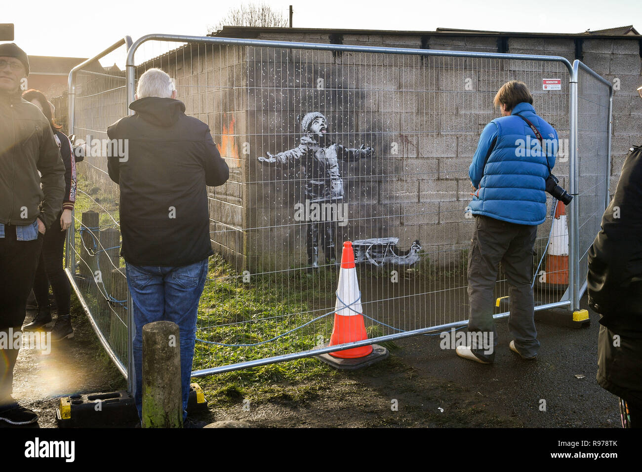Metal fencing protects an artwork by street artist Banksy, which has ...