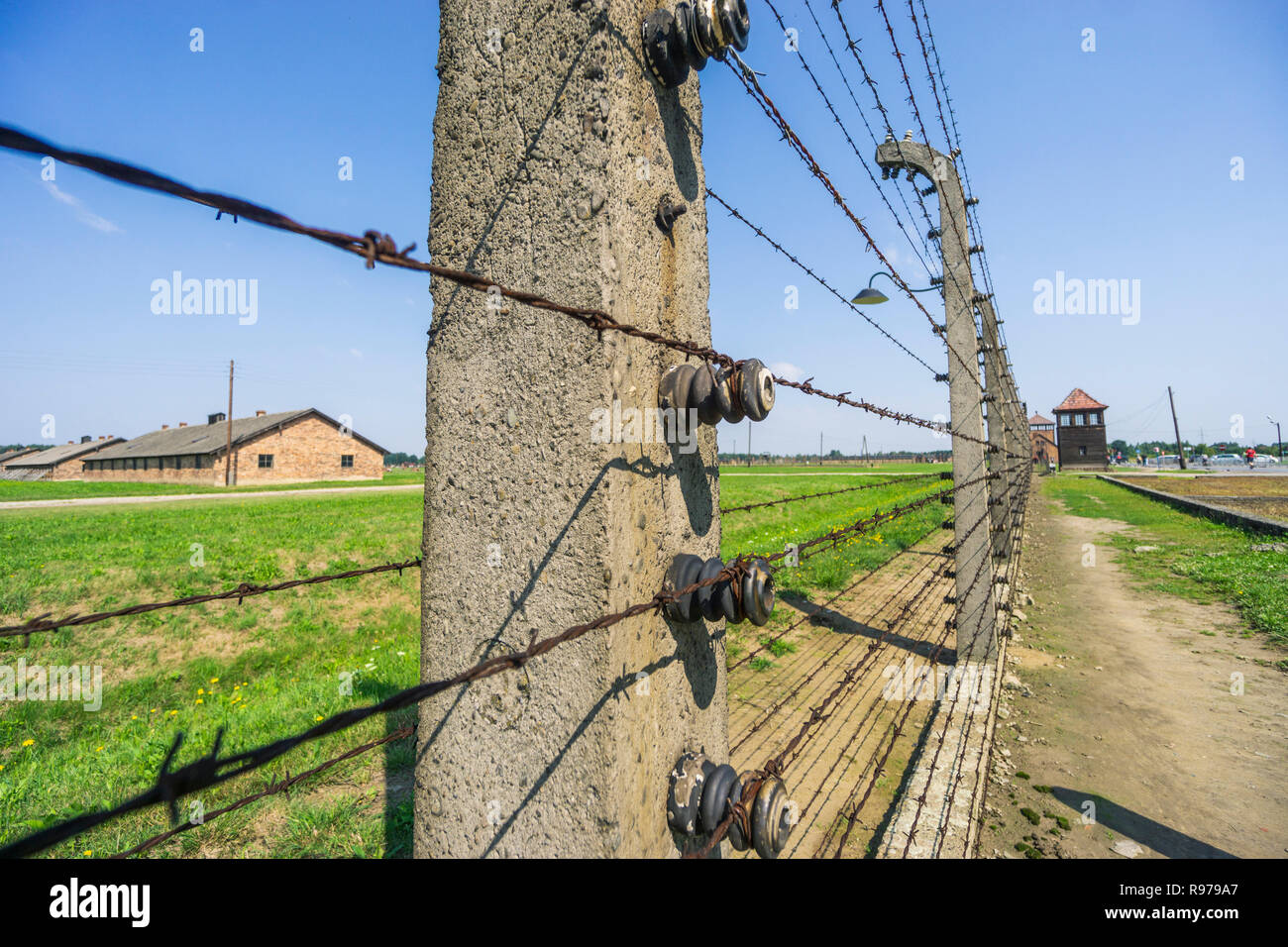 Fence and watchtower surrounding residential buildings in Auschwitz ...