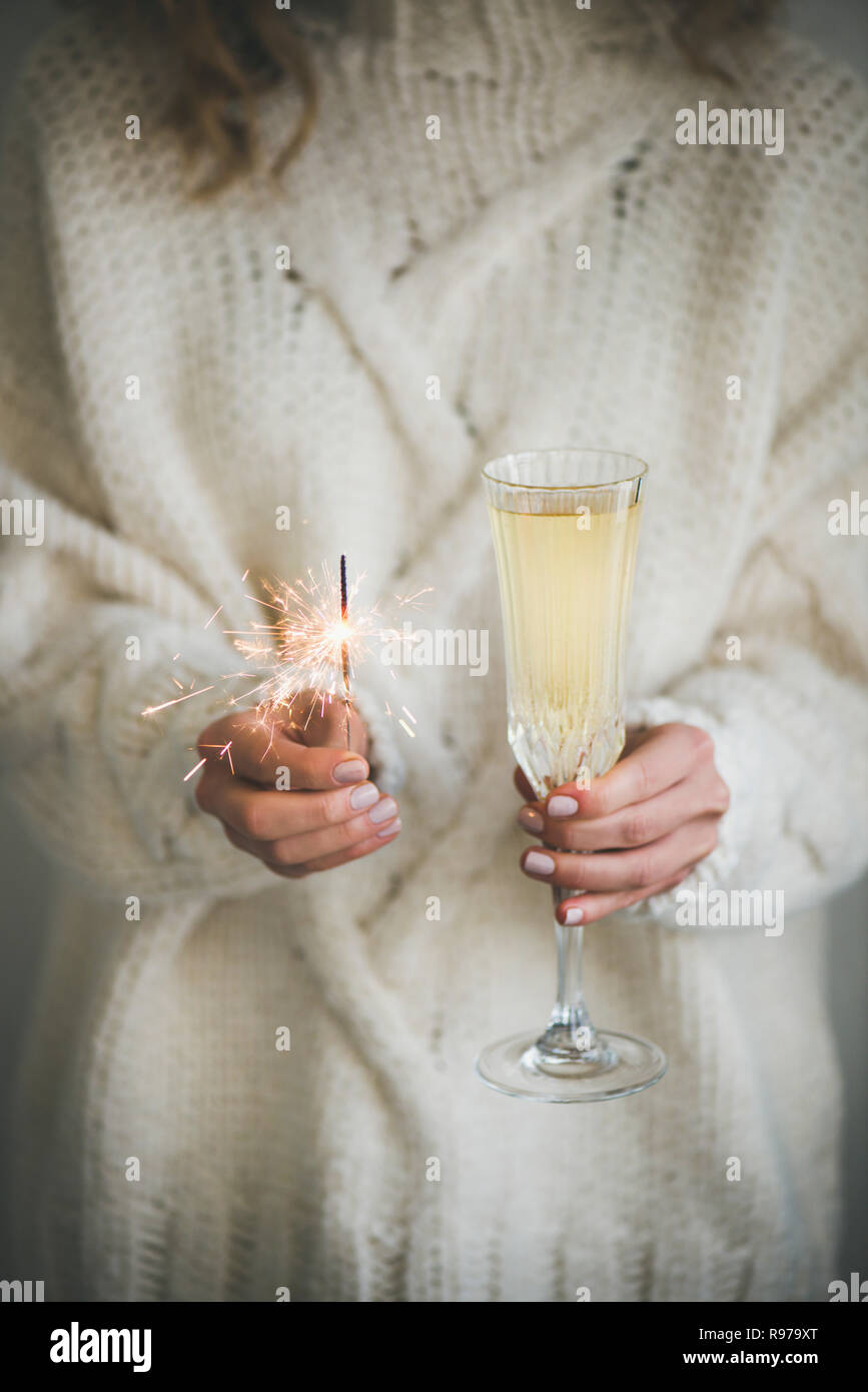 Christmas or New Year celebration concept. Woman in white woolen ...