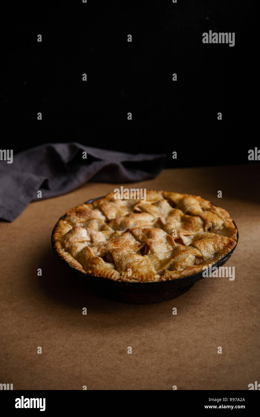 Apple pie with lattice decoration on beige background with a textile ...