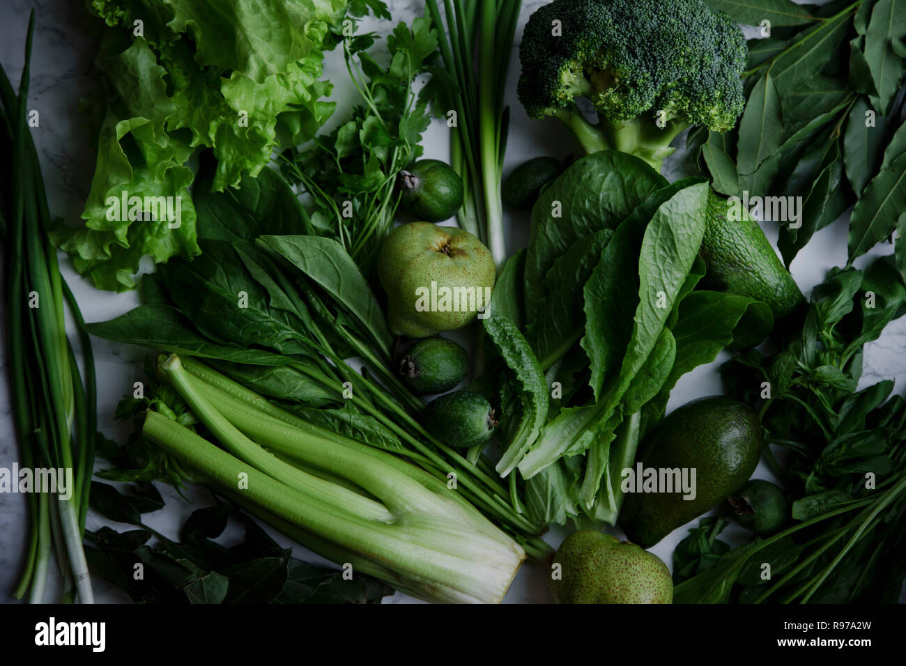 Fresh green food, variety of vegetables, greens and fruits on marble ...