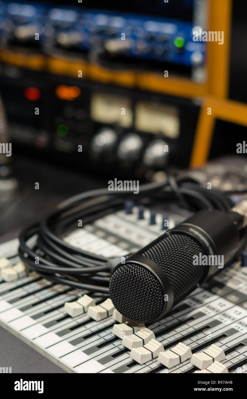 Close up of microphone with equipment on mixer in music studio, music ...
