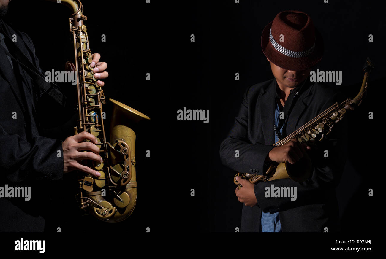 A saxophone player in a dark background Stock Photo - Alamy