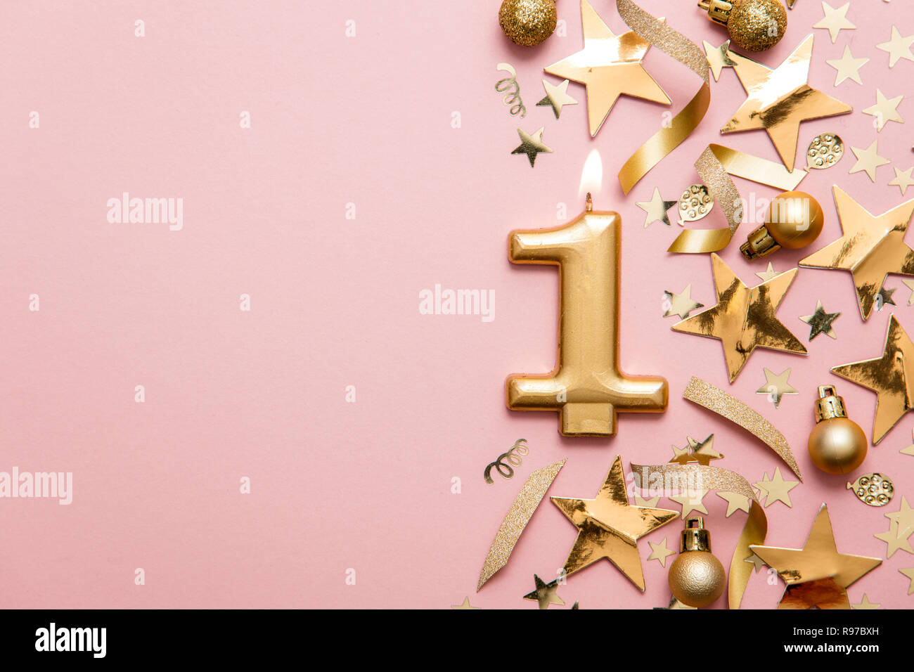 Number 1 gold celebration candle on star and glitter background Stock ...