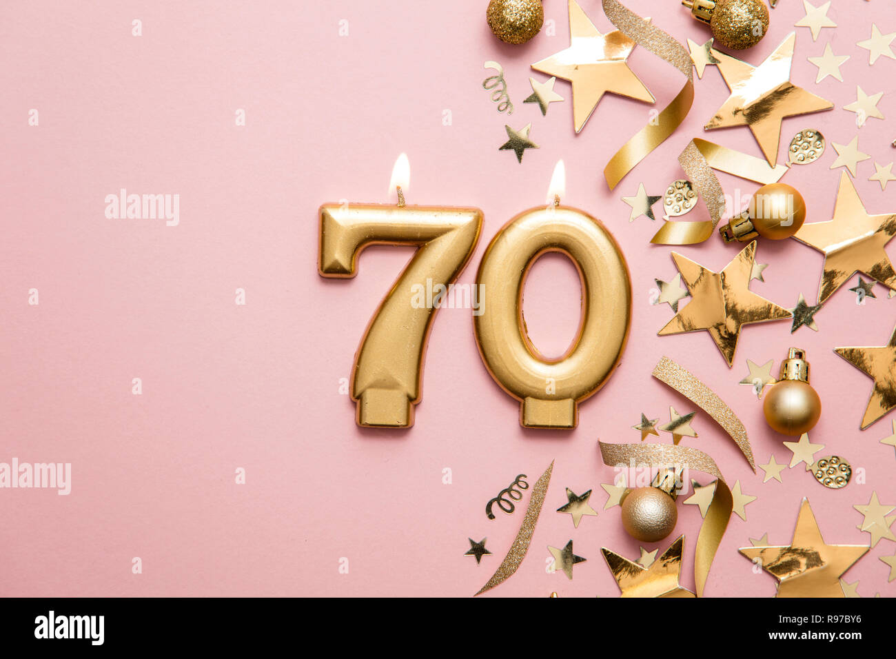 Number 70 gold celebration candle on star and glitter background Stock ...