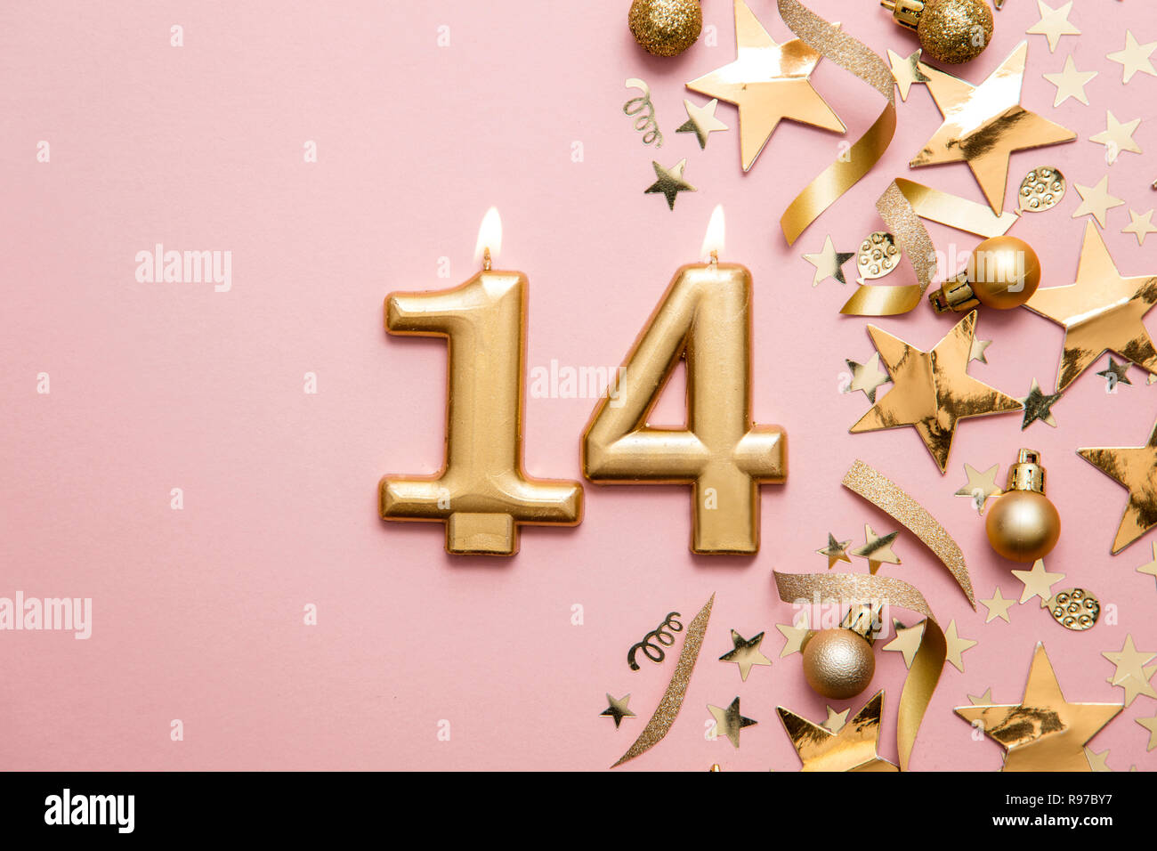 Number 14 gold celebration candle on star and glitter background Stock ...