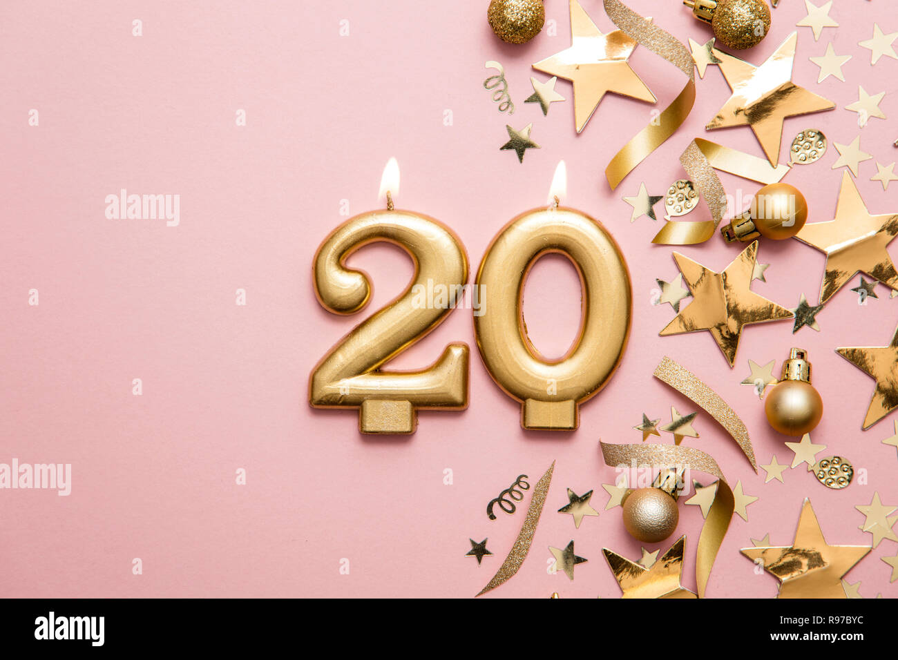 Number 20 gold celebration candle on star and glitter background Stock ...