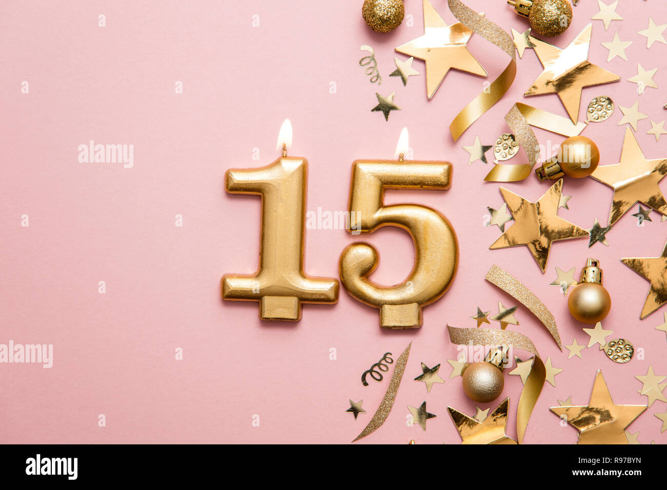 Number 15 gold celebration candle on star and glitter background Stock ...