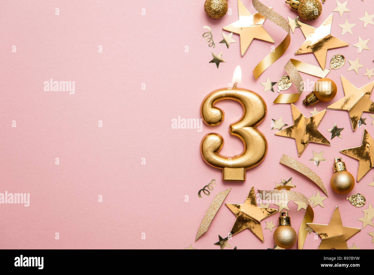 Number 3 gold celebration candle on star and glitter background Stock ...