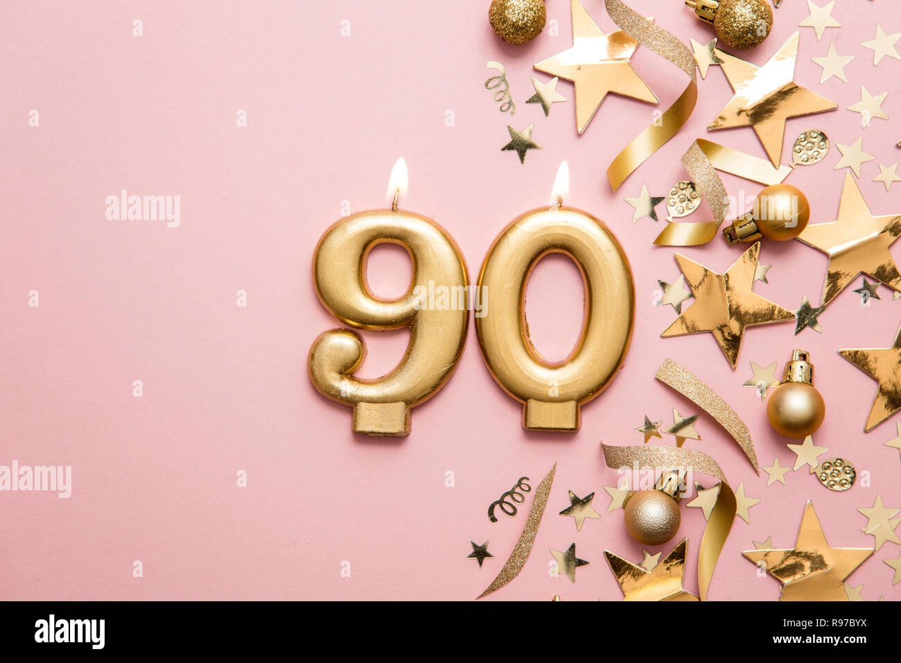 Number 90 gold celebration candle on star and glitter background Stock ...
