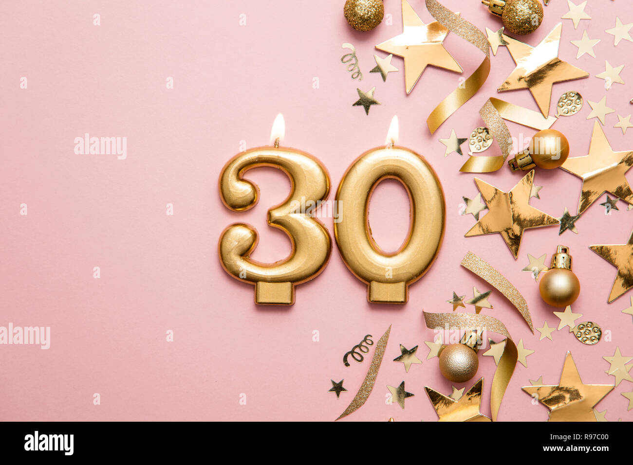 Number 30 gold celebration candle on star and glitter background Stock ...