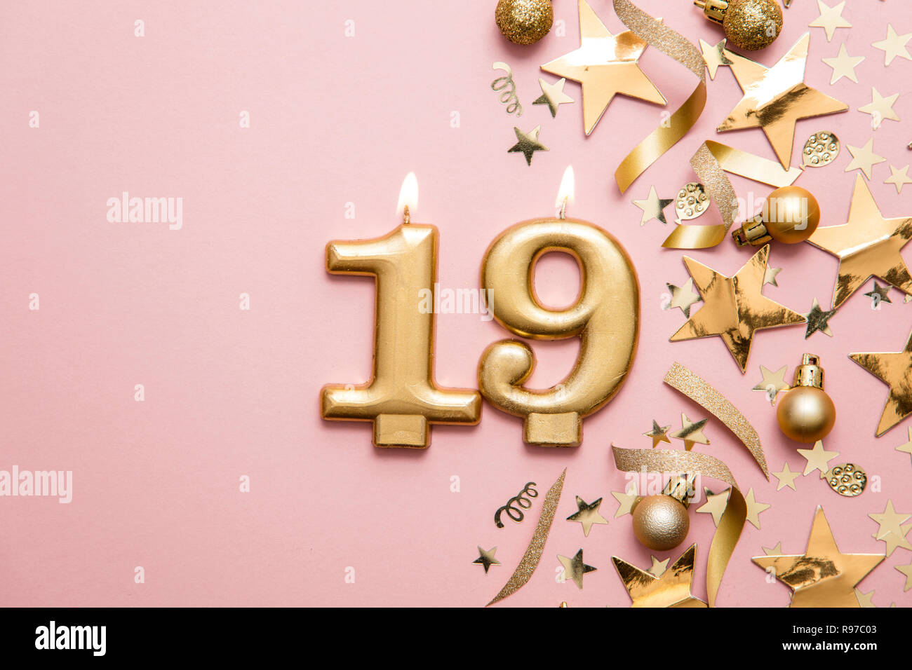 Number 19 gold celebration candle on star and glitter background Stock ...