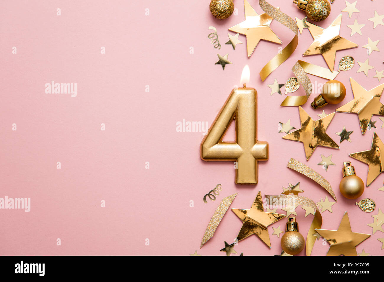 Number 4 gold celebration candle on star and glitter background Stock ...