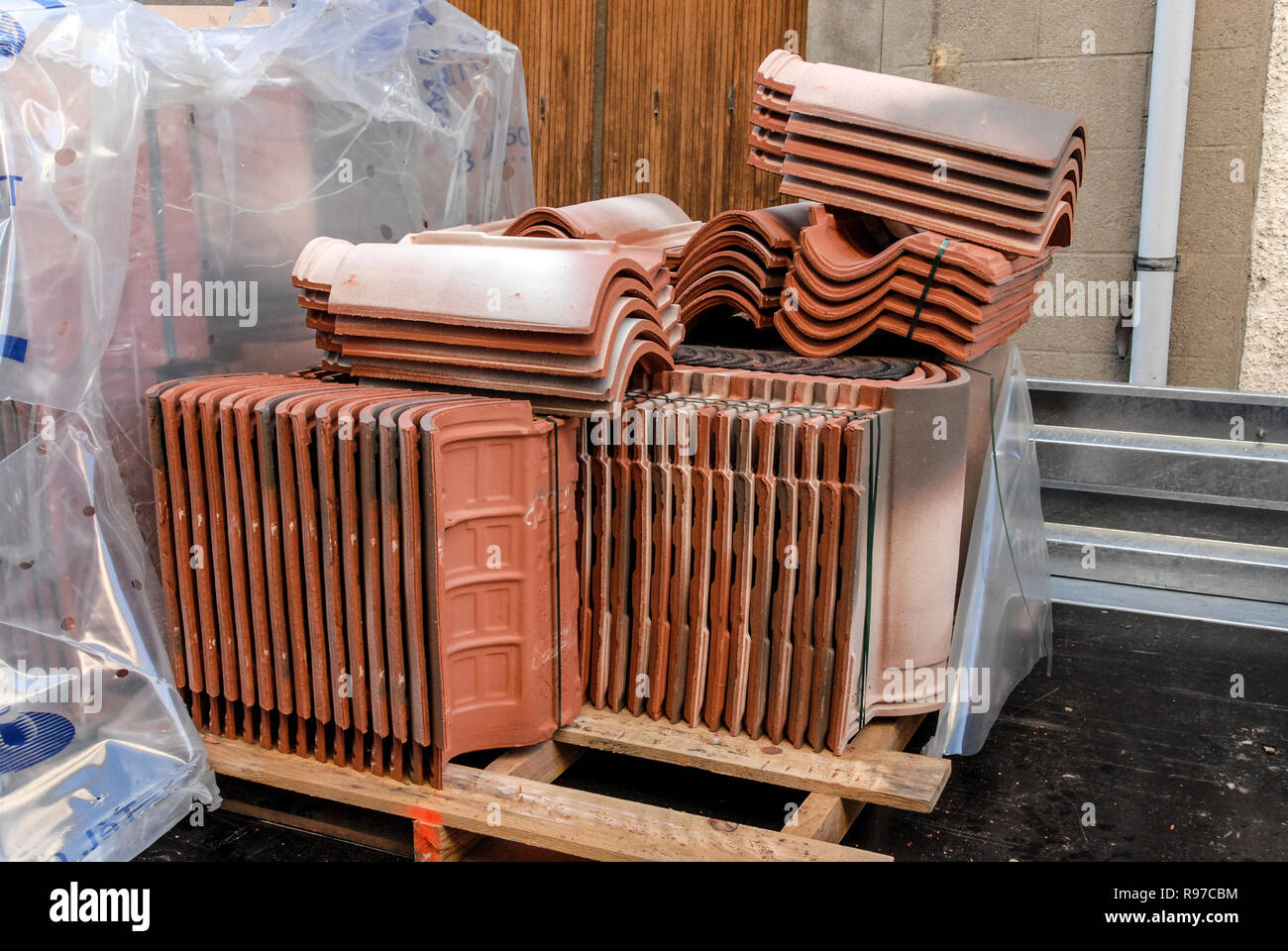 A stack of Terracotta tiles loaded on a trailer at a house in need of a ...
