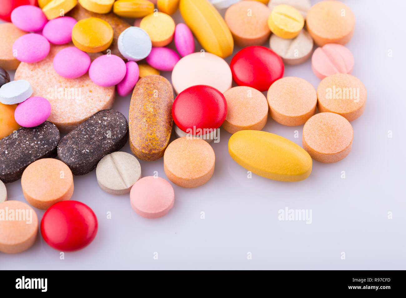 Tablets pills capsule heap mix therapy drugs, over a white background ...