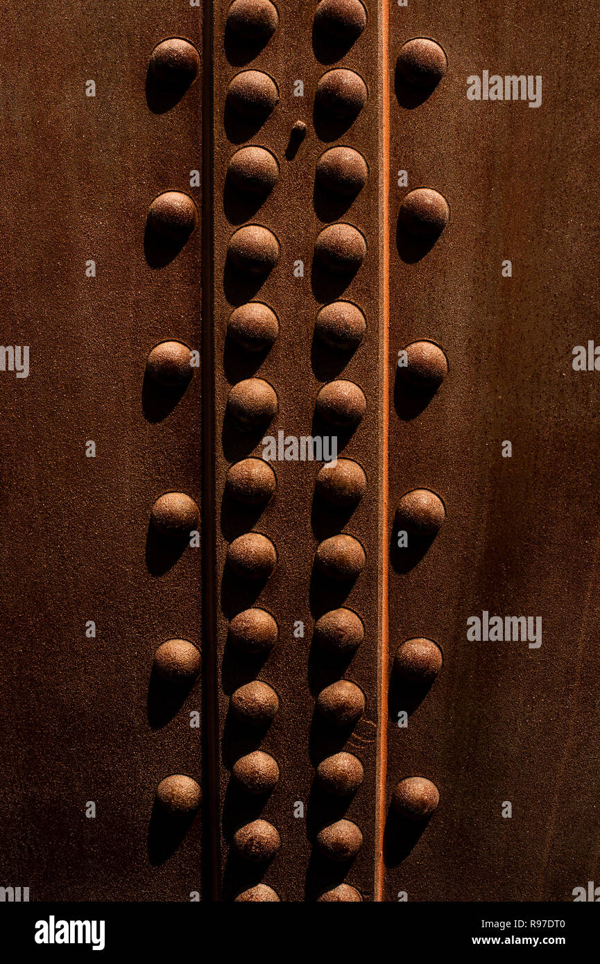 Rivets close-up along metal storage tank creating a design element ...