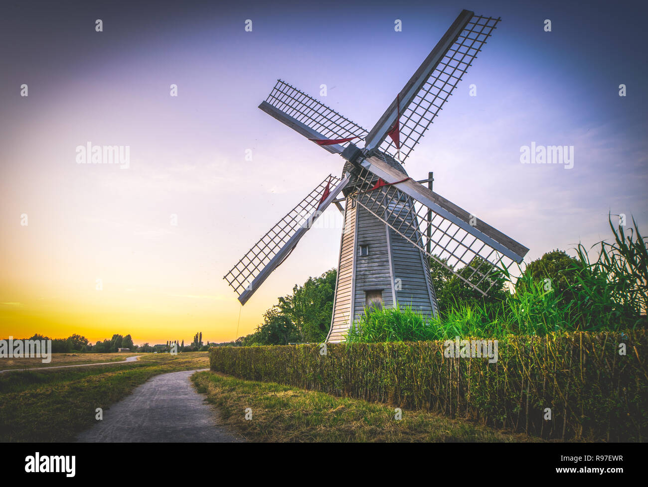 Still windmill in the countryside after sunset in france Stock Photo ...