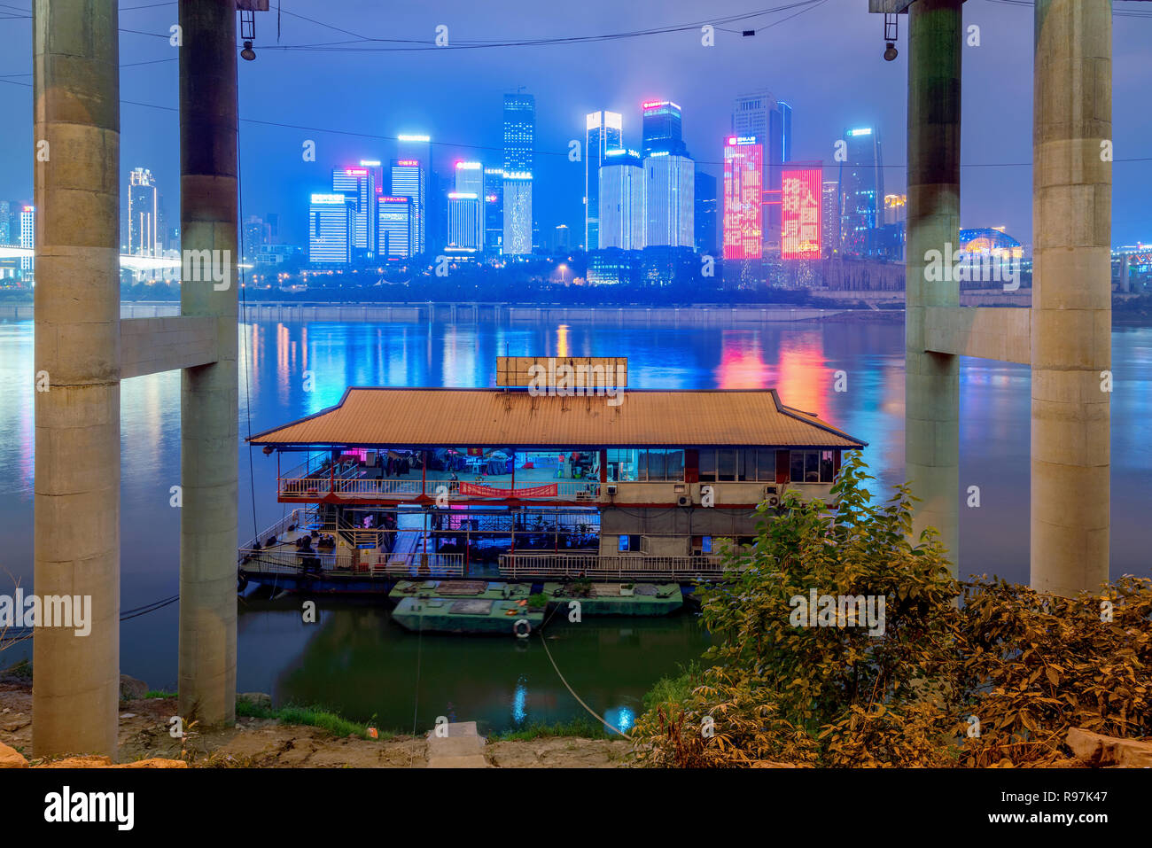 View of a bridge with a boat and Chongqing city buildings on the ...