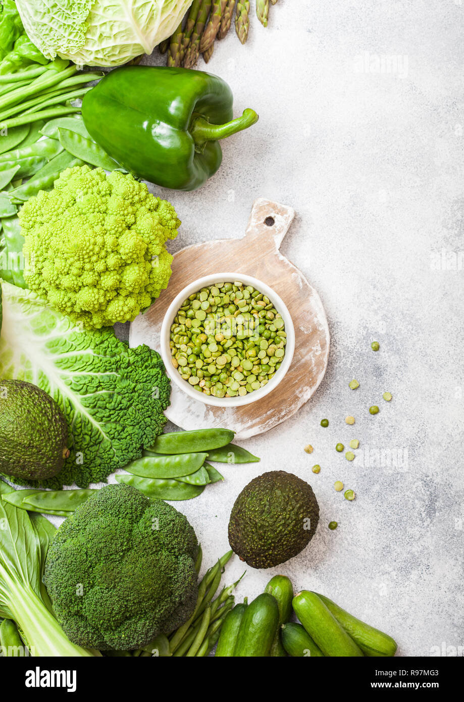 Assorted green toned raw organic vegetables on white background ...