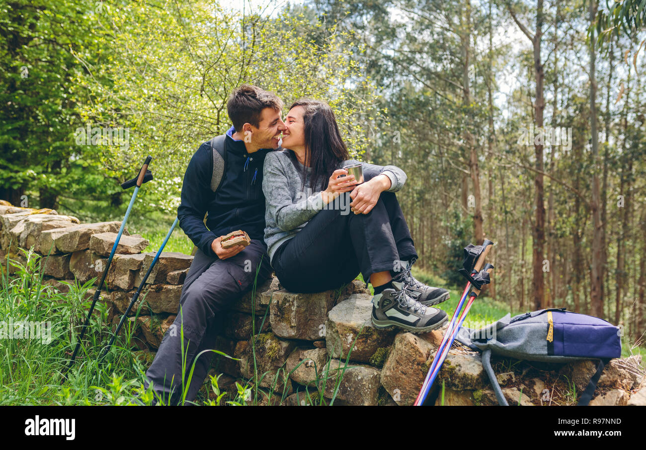 Couple about to kiss while making a break to do trekking Stock Photo ...