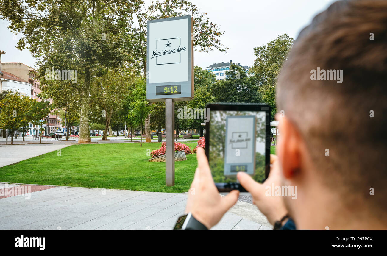 Man taking photo with tablet to customizable advertising poster Stock ...