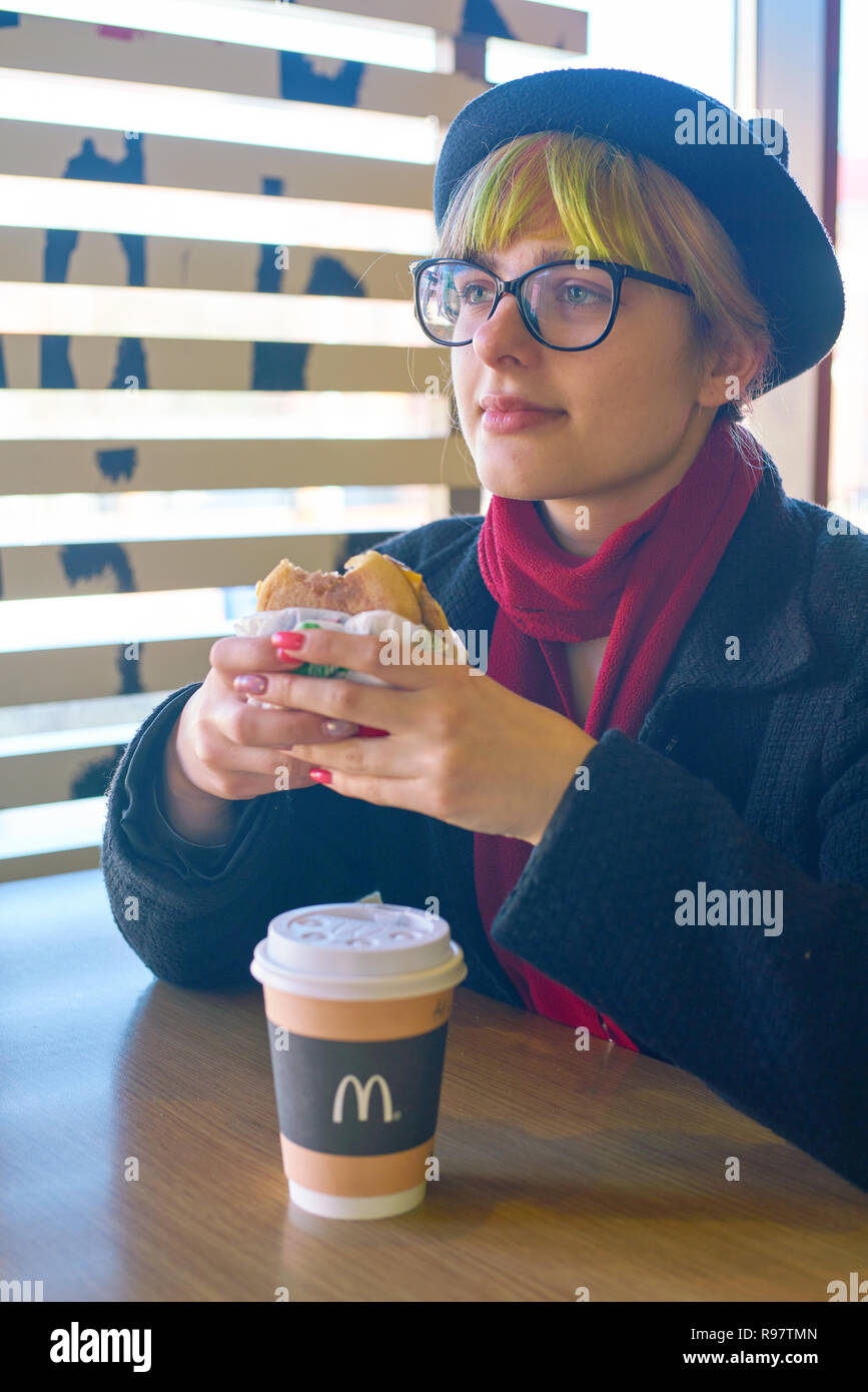 KALININGRAD, RUSSIA - CIRCA APRIL, 2018: caucasian woman eats at ...