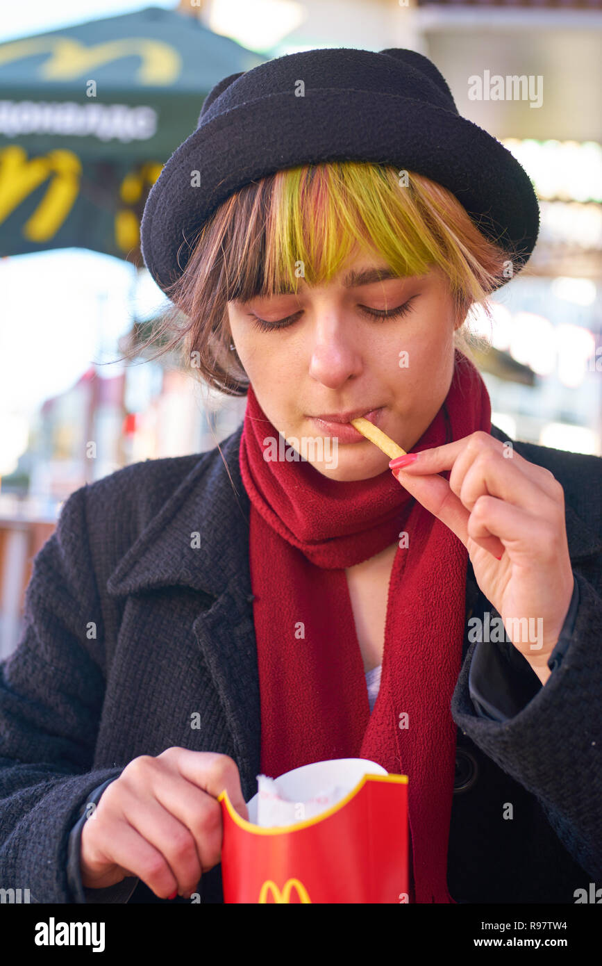 KALININGRAD, RUSSIA - CIRCA APRIL, 2018: caucasian woman eats at ...