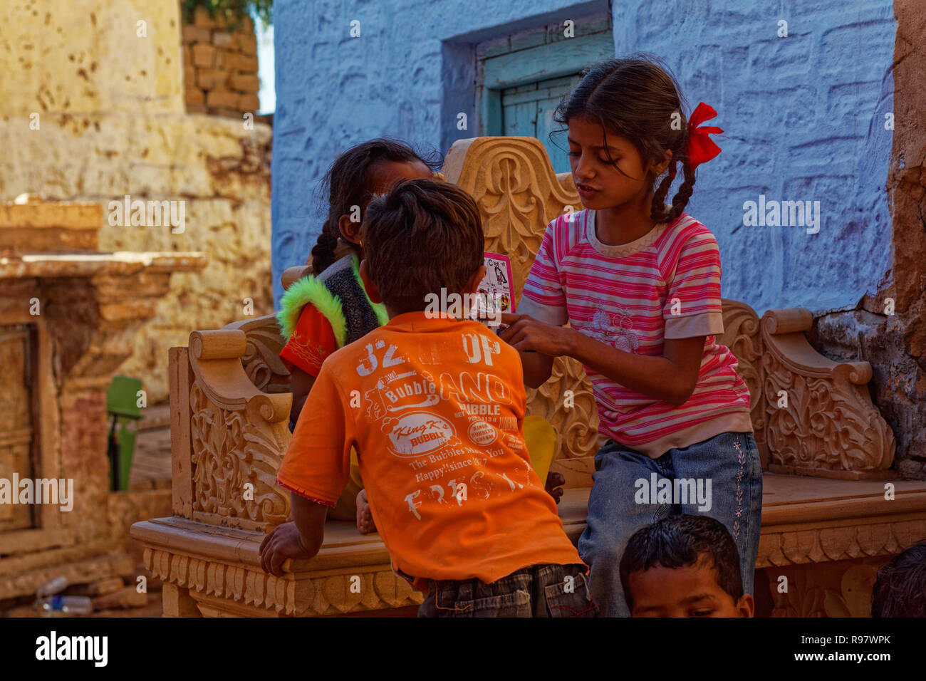 Older sister teaching siblings Stock Photo - Alamy