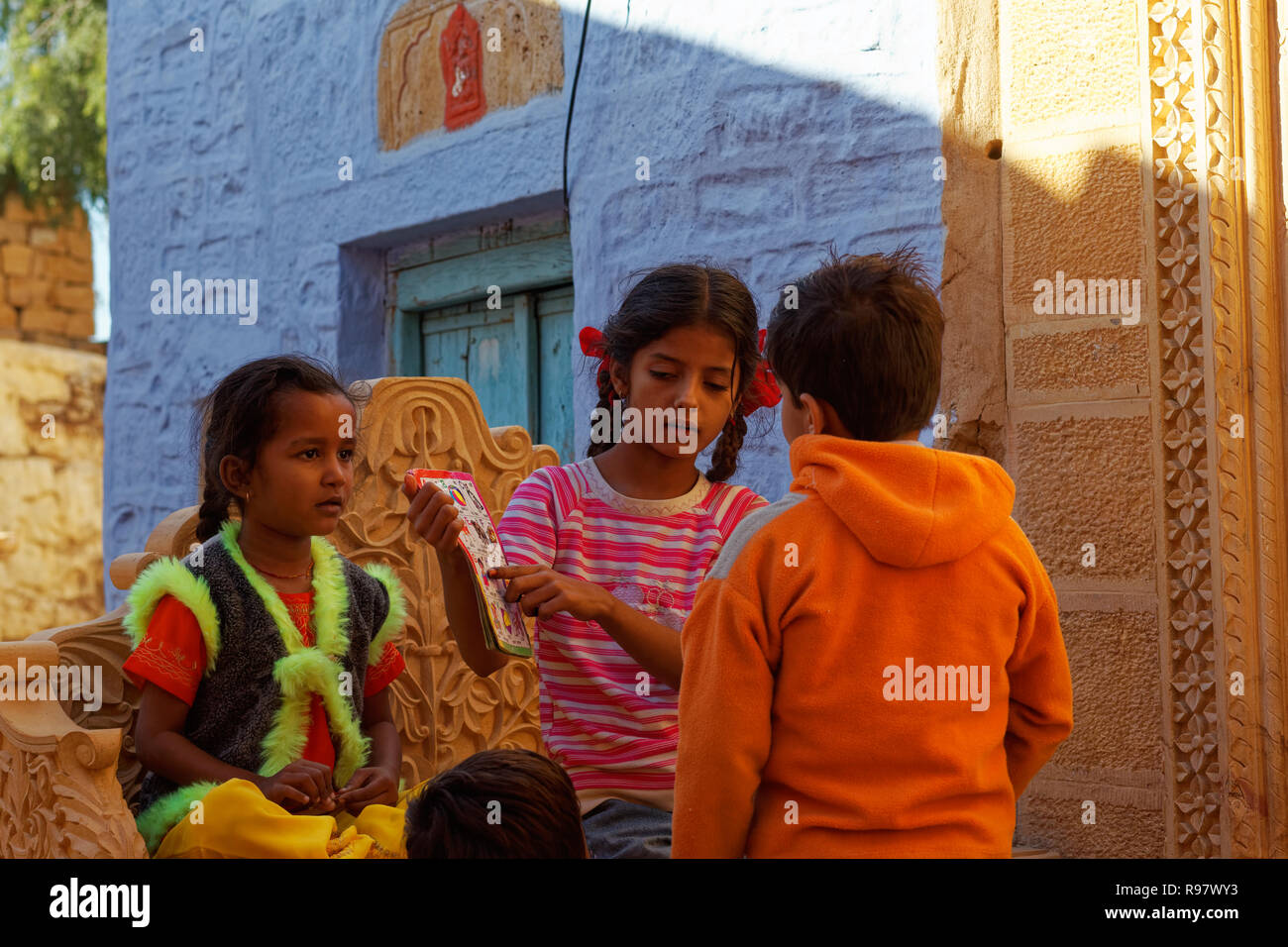 Older sister teaching siblings Stock Photo - Alamy