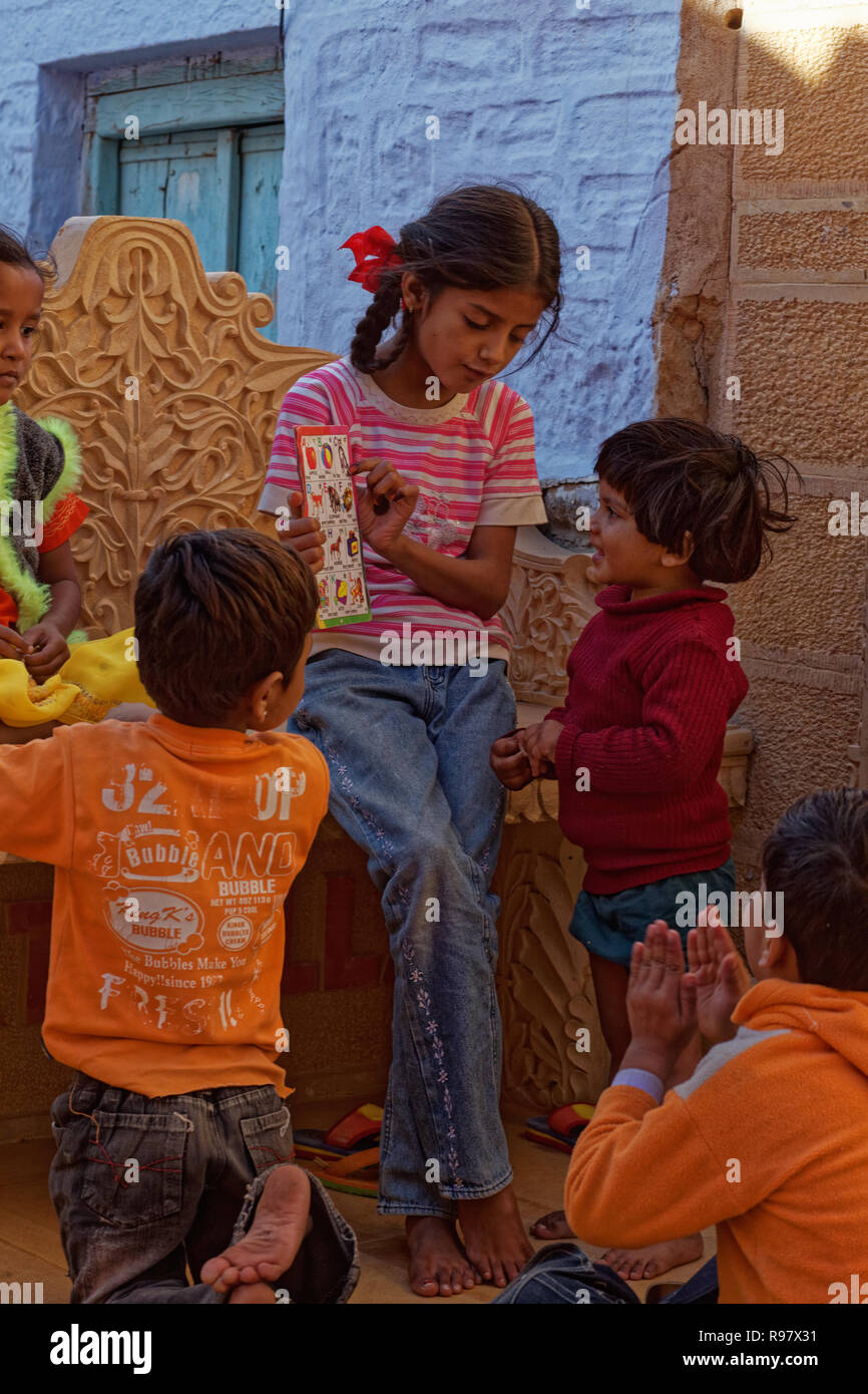 Older sister teaching siblings Stock Photo - Alamy