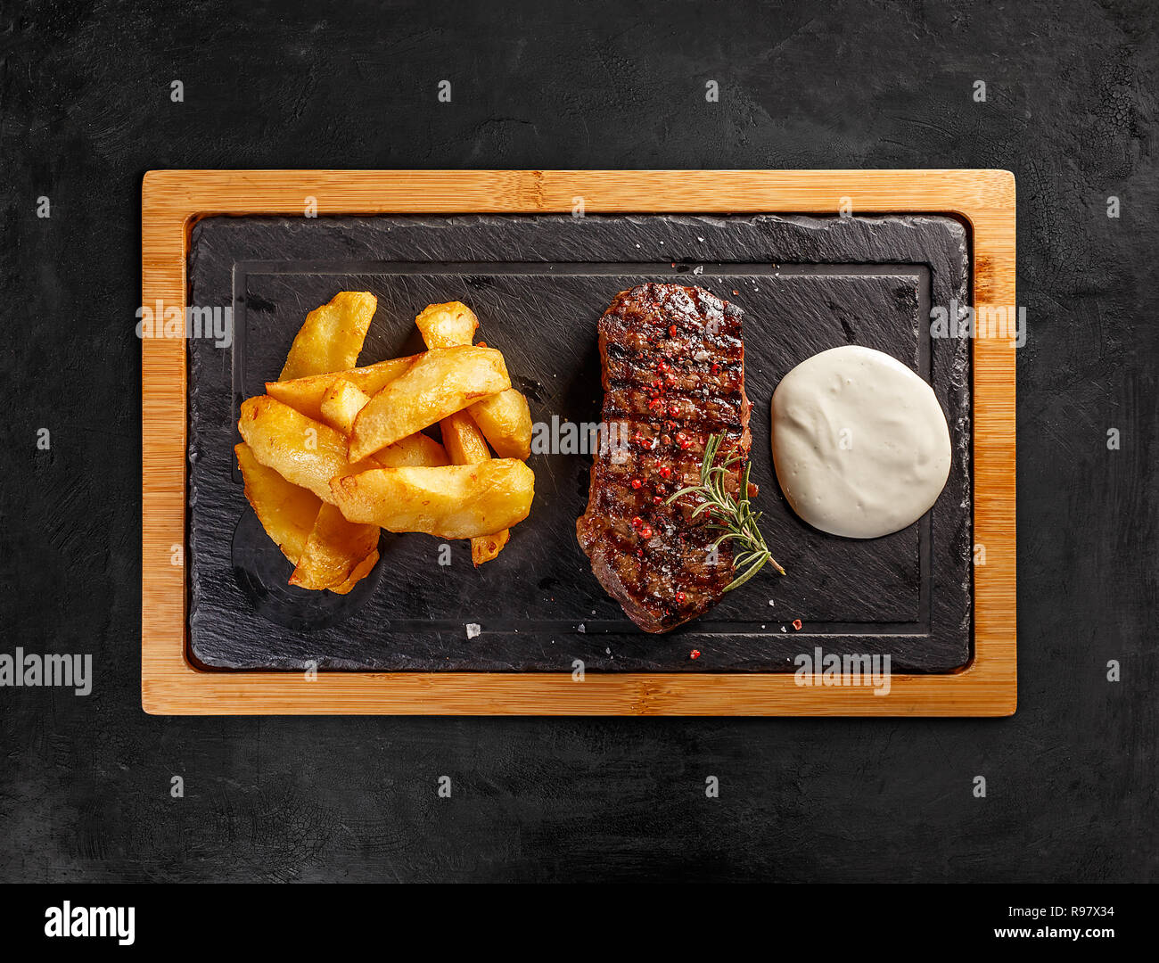 Matured Argentinian sirloin steak with golden potatoes and gorgonzola ...