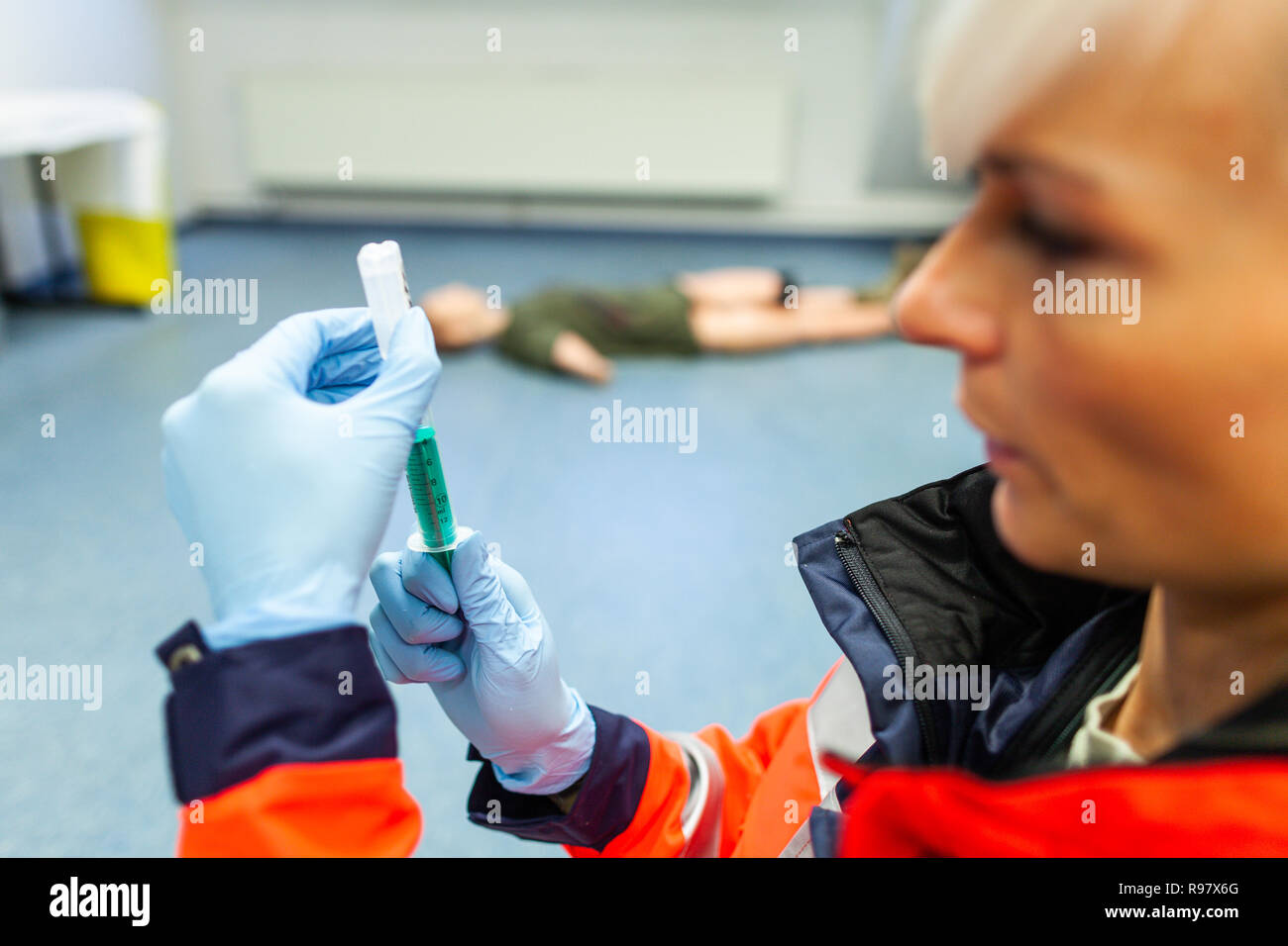 German paramedic picks up a syringe for a patient Stock Photo - Alamy