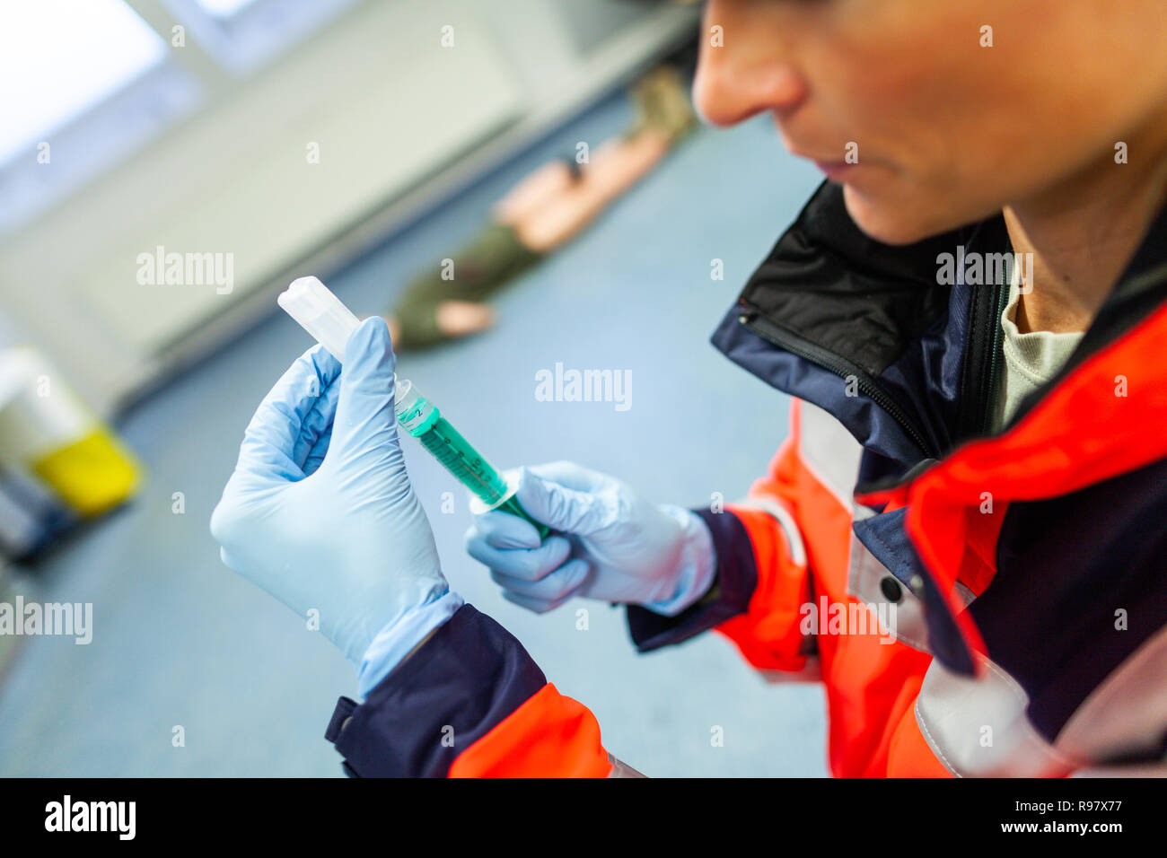 German paramedic picks up a syringe for a patient Stock Photo - Alamy