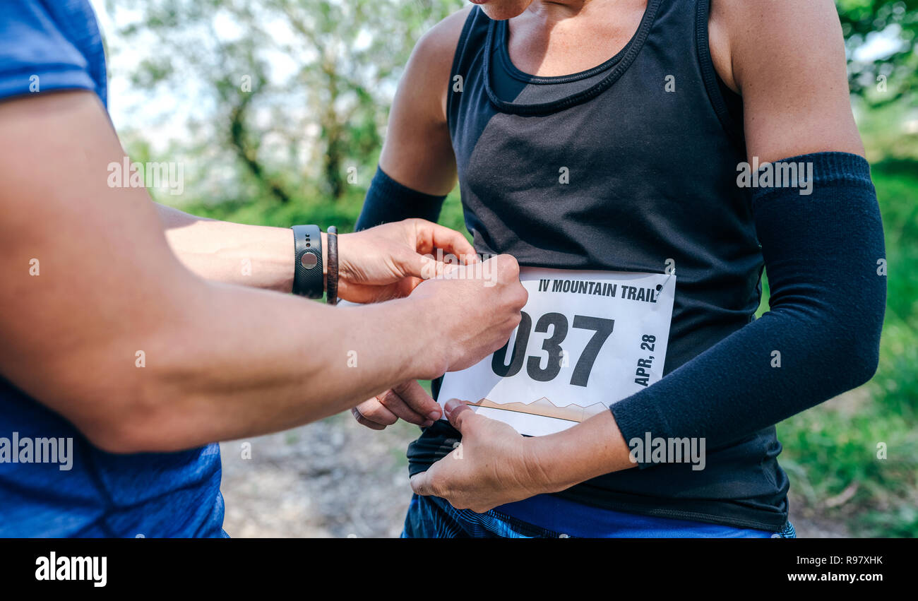 Girl placing the race number Stock Photo - Alamy