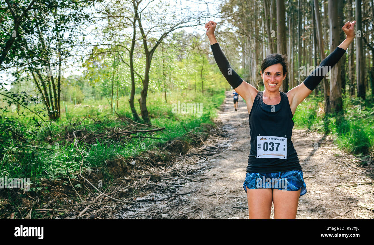 Young woman winning trail race Stock Photo - Alamy