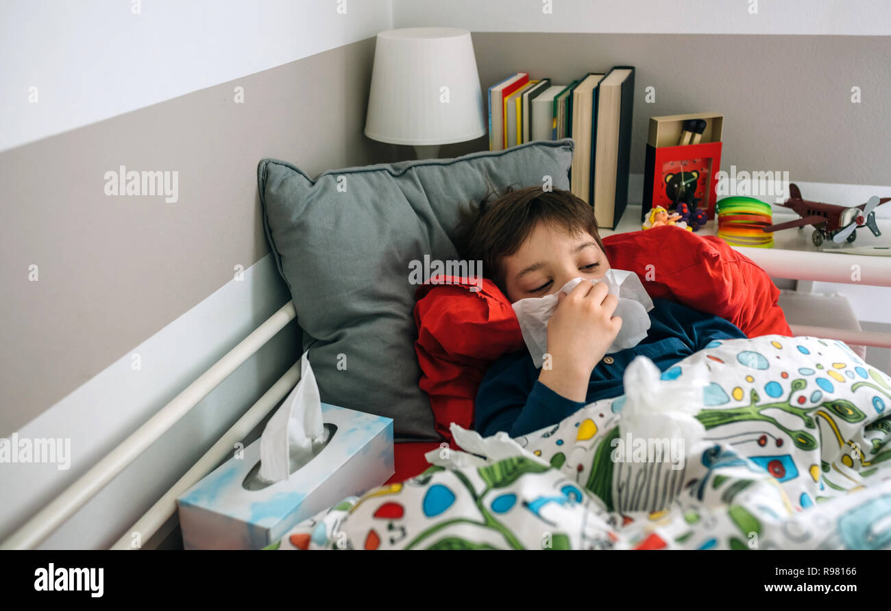 Cold child lying on the bed Stock Photo - Alamy