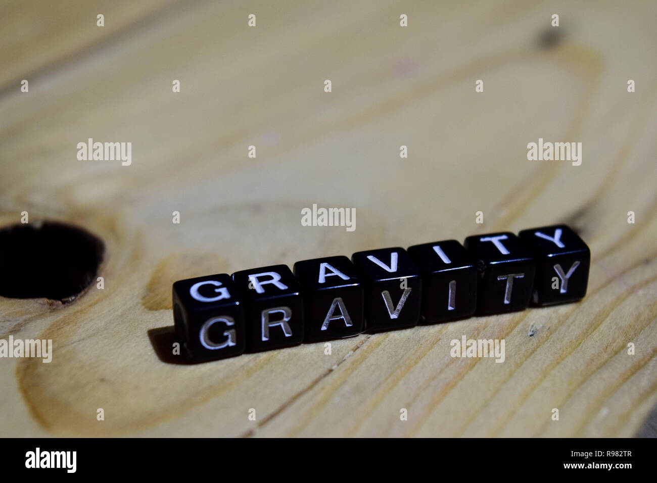Gravity written on wooden blocks. Inspiration and motivation concepts ...