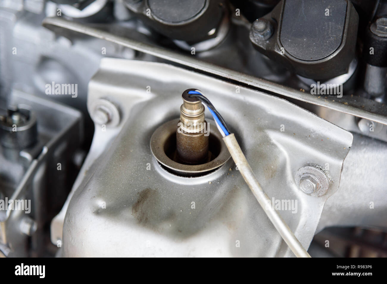 Oxygen sensor at intake of car Stock Photo - Alamy