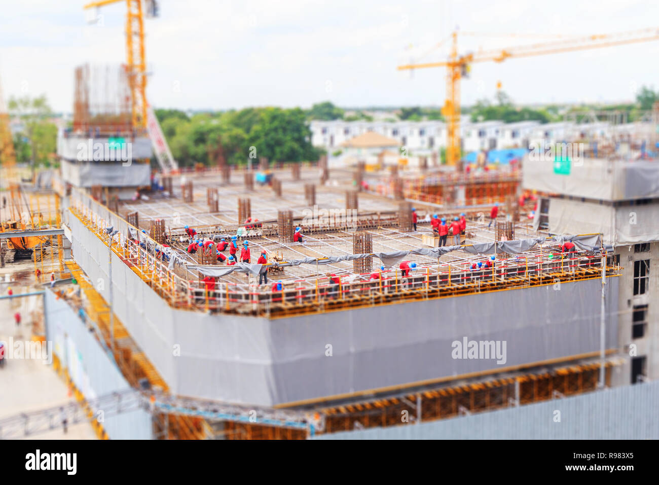 worker at high building construction /construction area in tilt shift ...