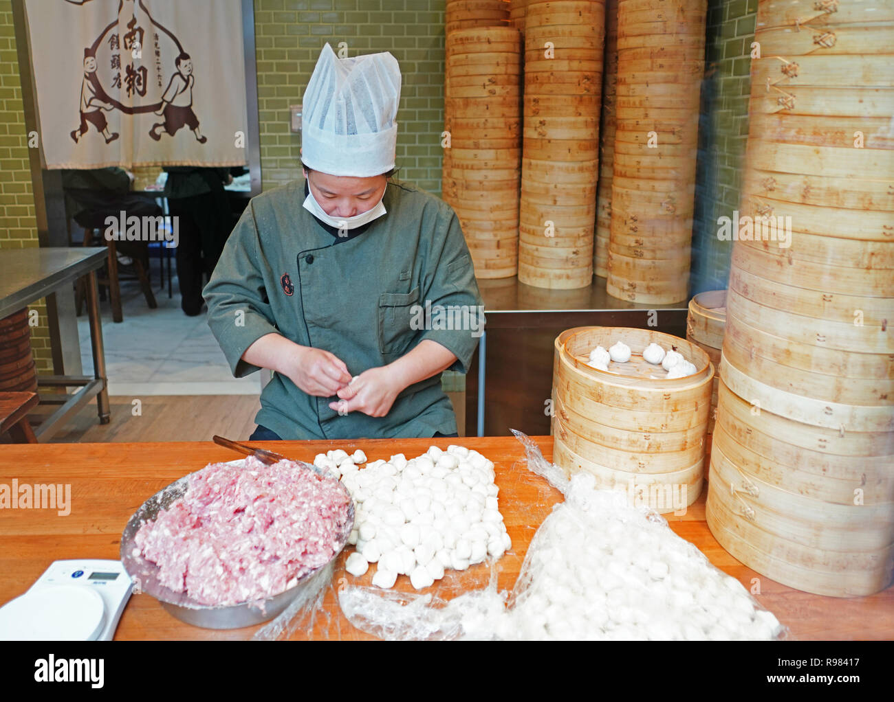 Woman Making Pork Filled Dumplings Dim Sum In Window Of The Famous