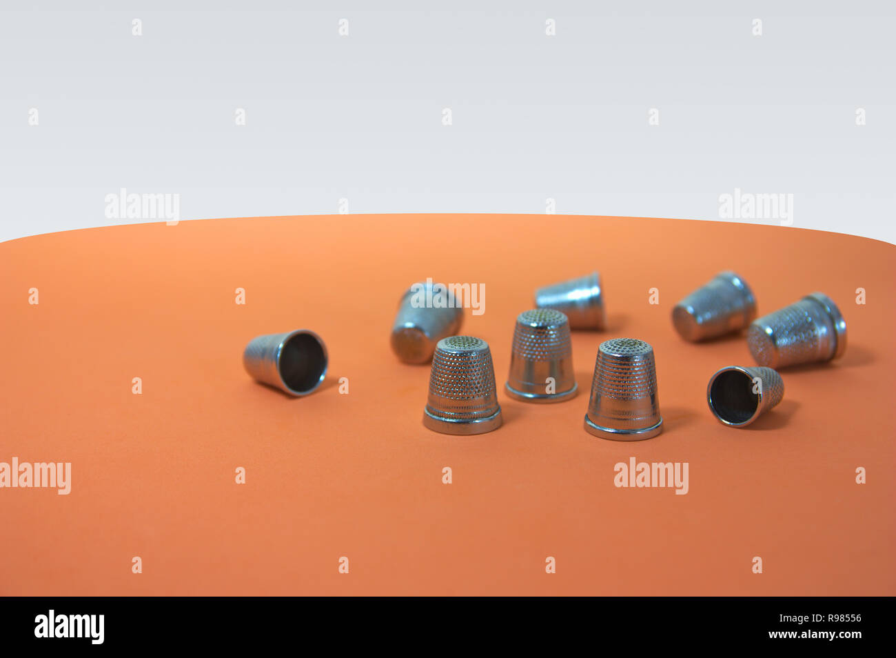 Image to write text (copy-space) next to a pile of disordered thimbles ...