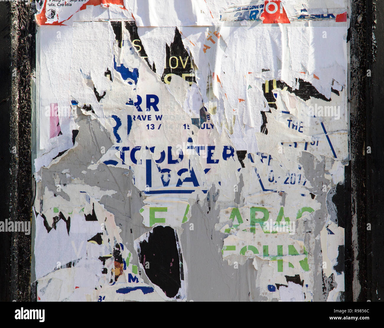 Torn posters on billboard Stock Photo - Alamy