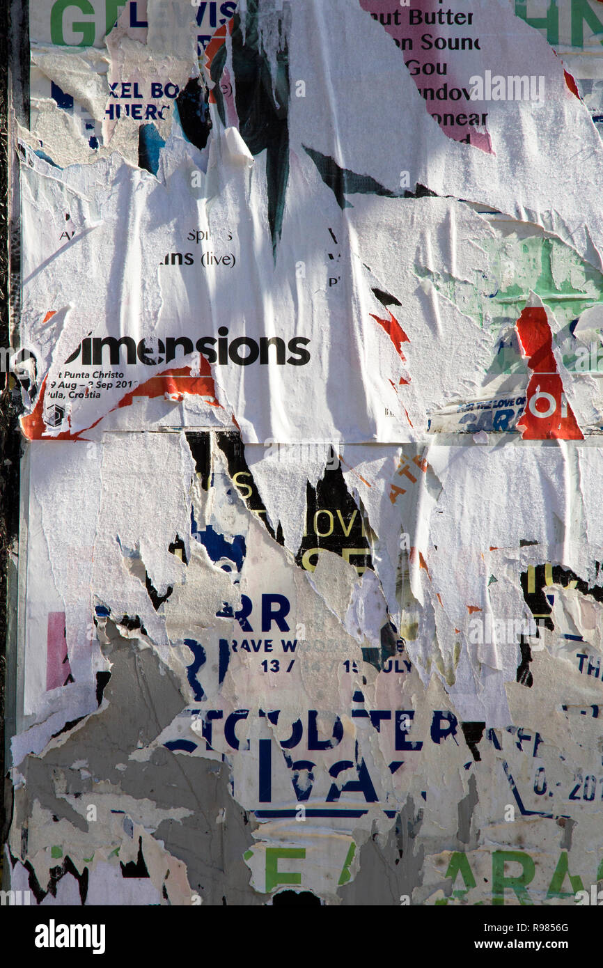 Torn posters on billboard Stock Photo - Alamy