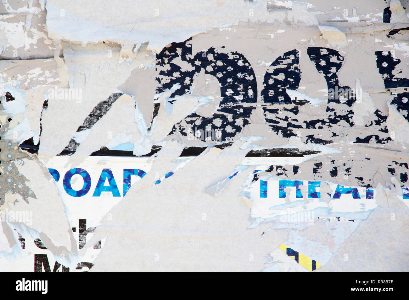 Torn posters on billboard Stock Photo - Alamy