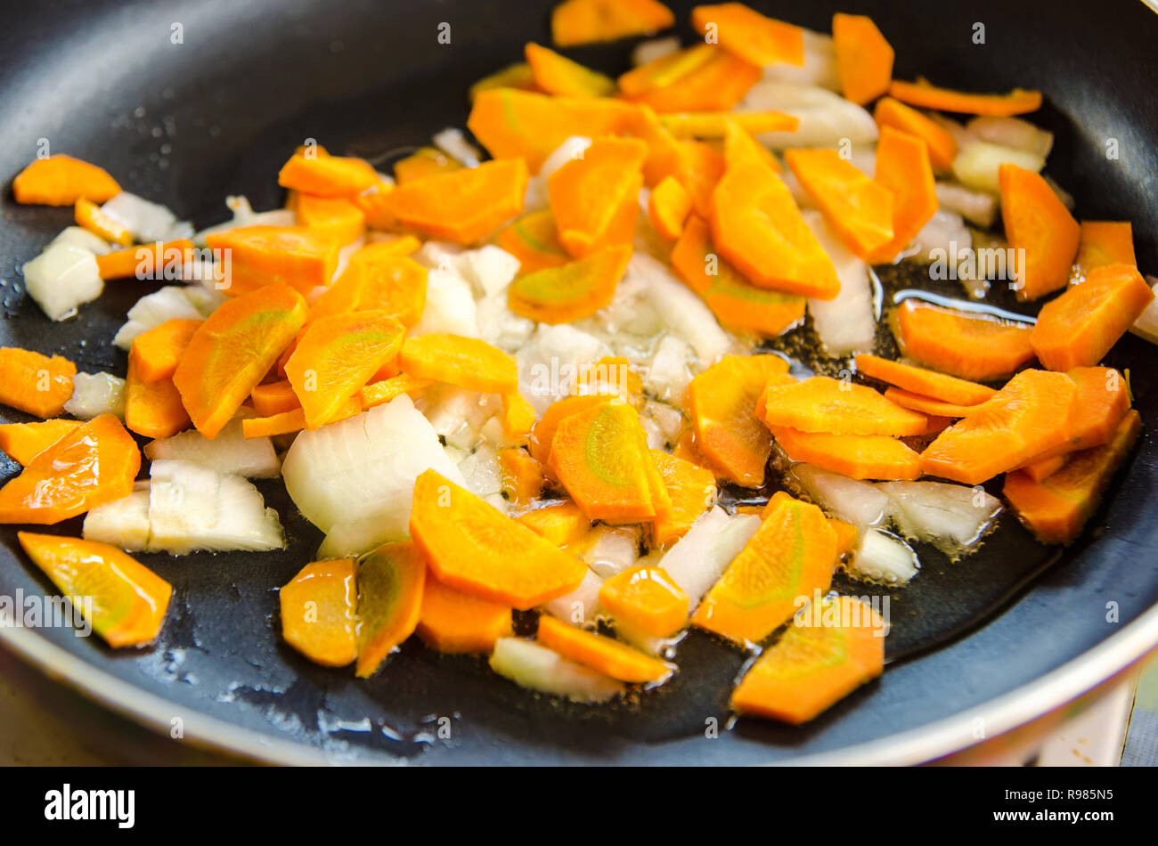 carrot and onion frying in pan Stock Photo - Alamy