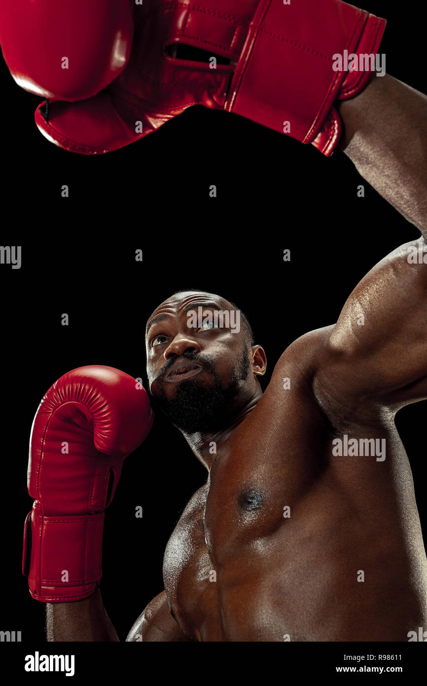 Hands of boxer over black background. Strength, attack and motion ...