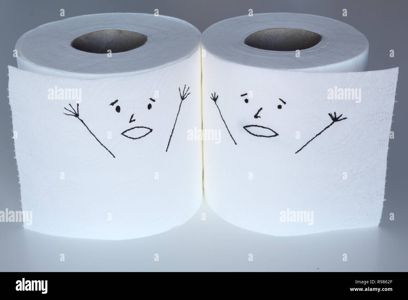 Two white toilet paper rolls sketched with discussing faces close to ...