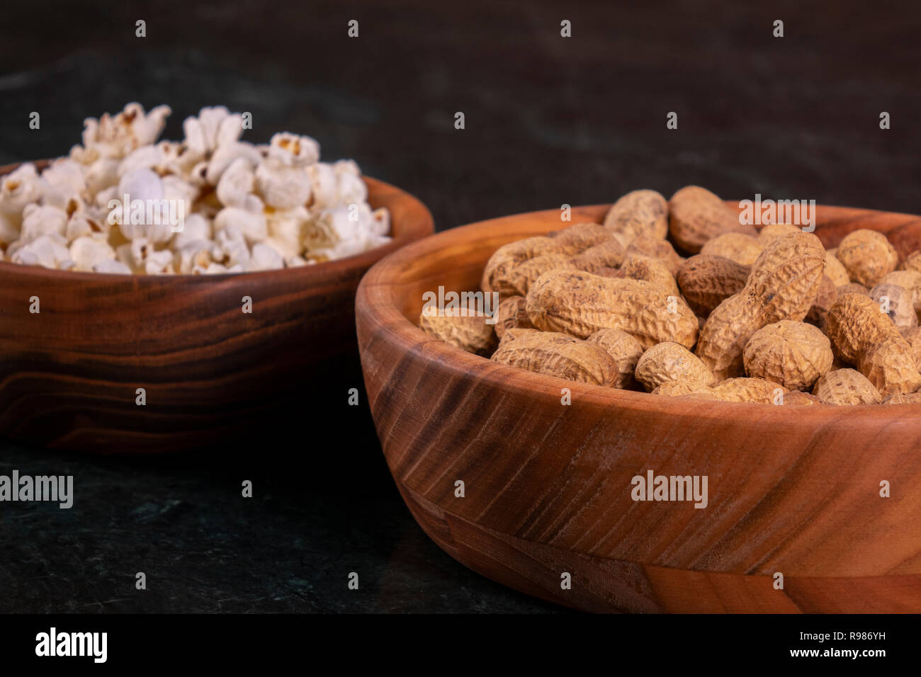 Peanuts with Popcorn in golden wood bowl on black marble table Stock ...