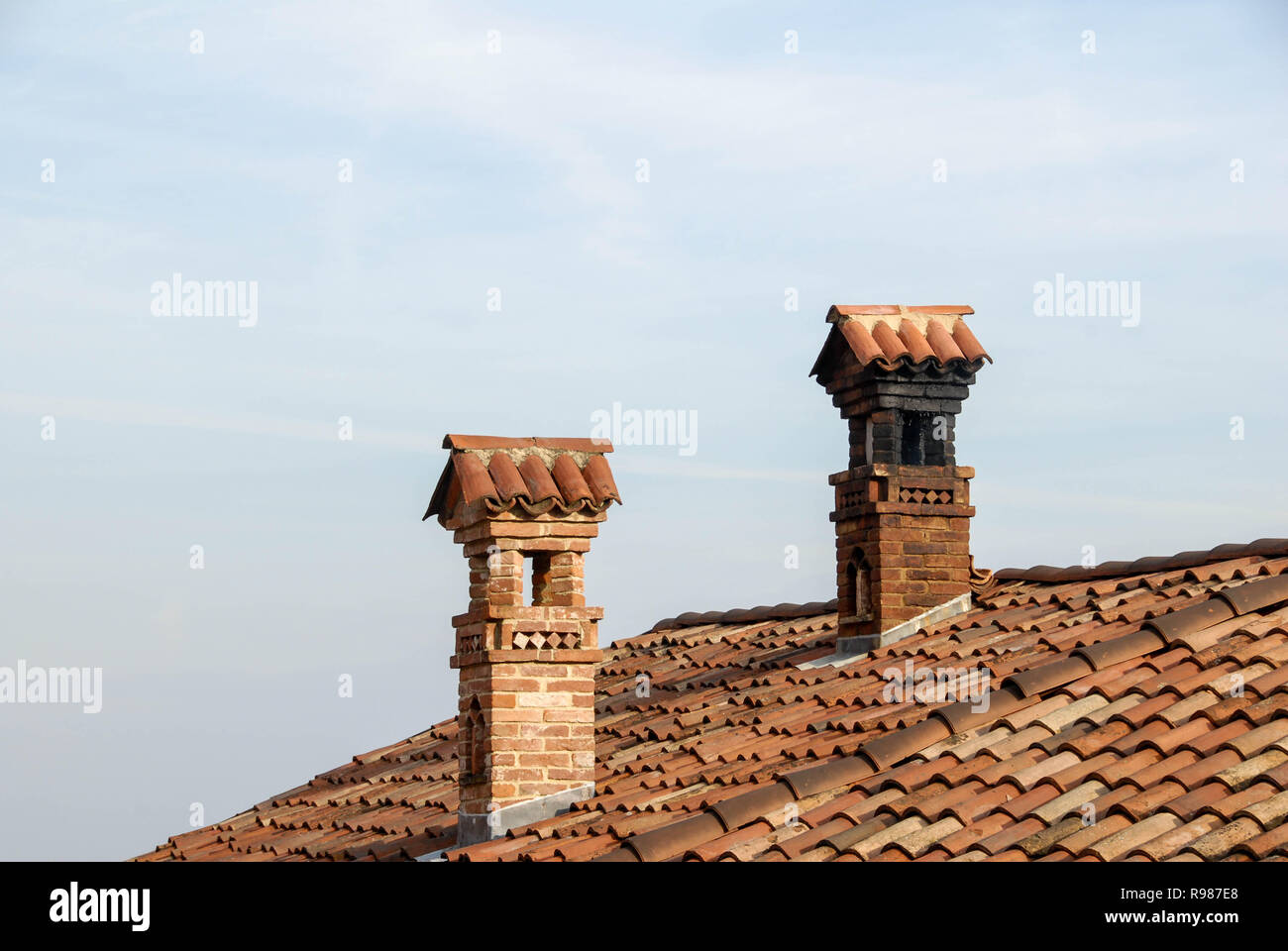 Two old chimneys on the roof with tiles Stock Photo - Alamy