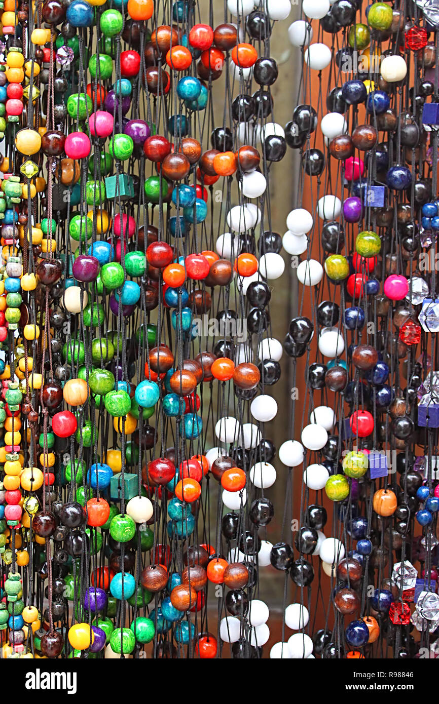 Hanging colourful beads and necklaces are sold by street vendor in ...